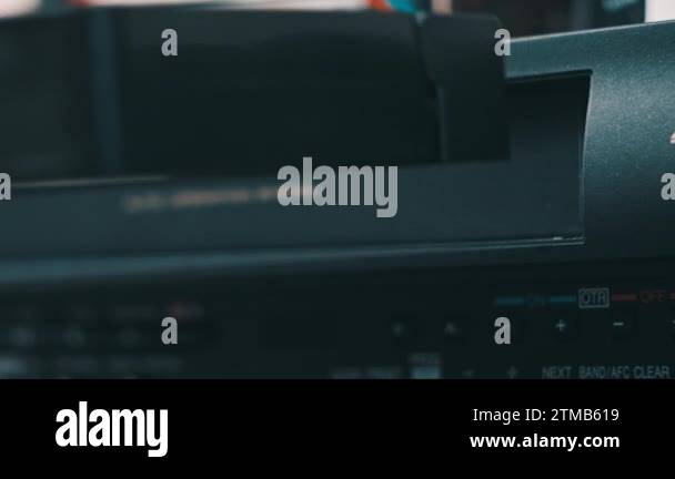 Insert VHS cassette into VCR player. Black vintage videotape cassette ...
