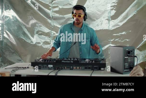 Sound engineer checking quality of music,having fun doing equalization ...