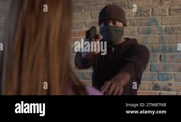 thief holding gun,bad man hold a gun pointing the target at young ...