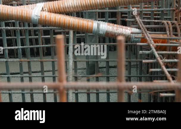 Pouring cement with long pipe into road bridge support foundation ...