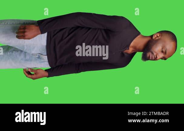 Vertical video: Side view of young male model feeling stylish posing on ...