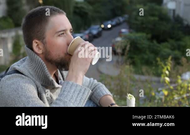 man eating kebab and drinking coffee Stock Video Footage - Alamy
