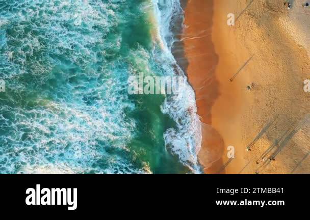 Cinematic aerial view beautiful beach washed by blue foamy ocean waves ...