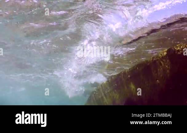 Close-up, wave twists into spiral in surf zone in shallow water forming ...