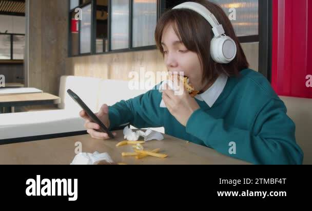 Teenage girl eating fast food and make a selfie - addiction to junk ...