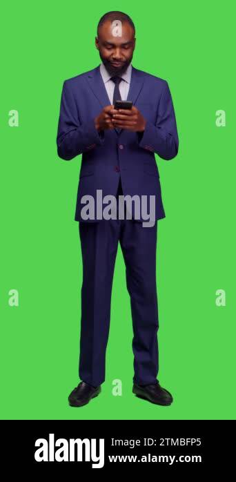 Vertical video: Front view of corporate employee texting messages on ...