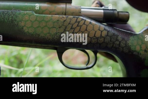 Closeup man or woman holding rifle in hand. Male finger in gloves ...