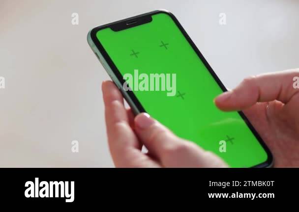 Girl scrolling phone green screen browsing social media chroma key ...