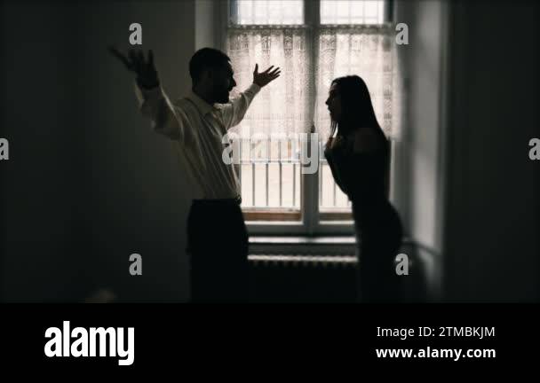 Silhouette of couple fighting each other, arguing and yelling at one ...