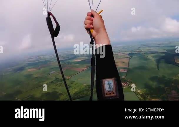 Skydiver uses hand-held parachute altimeter to know height. Man ...