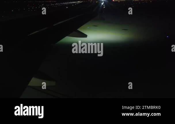Airplane moving on taxiway. View from the plane window of the lights on ...