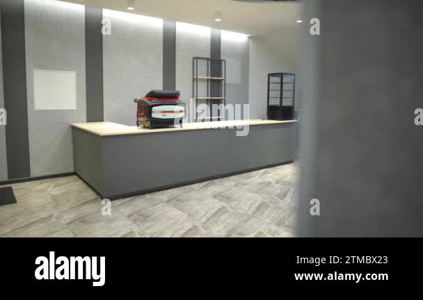 Wide shot empty office lobby with stairs and coffee machine on desk. No ...