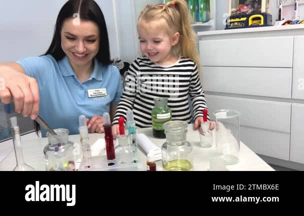 Close-up of colored science test tubes with a blurry background of two ...