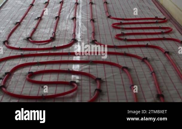 Underfloor heating in construction of new residential house. Pipefitter ...
