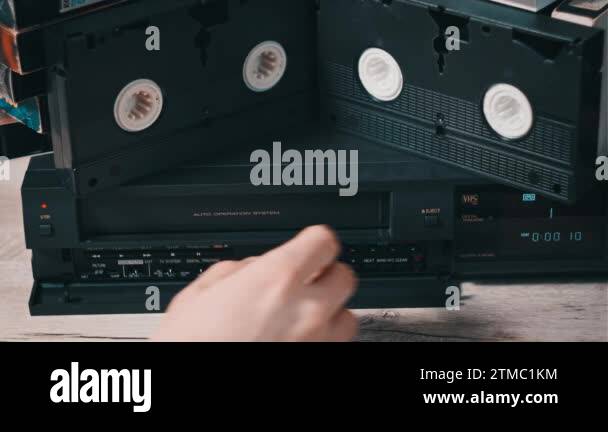 Male hand pulls out VHS from a vintage videotape recorder. Eject VHS ...