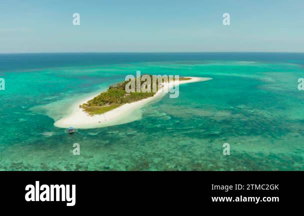 Tropical island Canimeran with sandy beach in the blue sea with coral ...