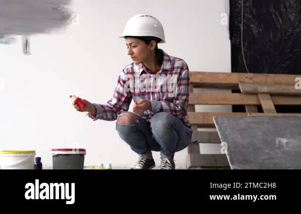 Remodeling house. Home remodel and renovation. Woman painting walls ...