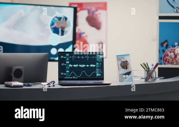 Cardiology diagnosis on laptop at desk, showing cardiogram and heart ...