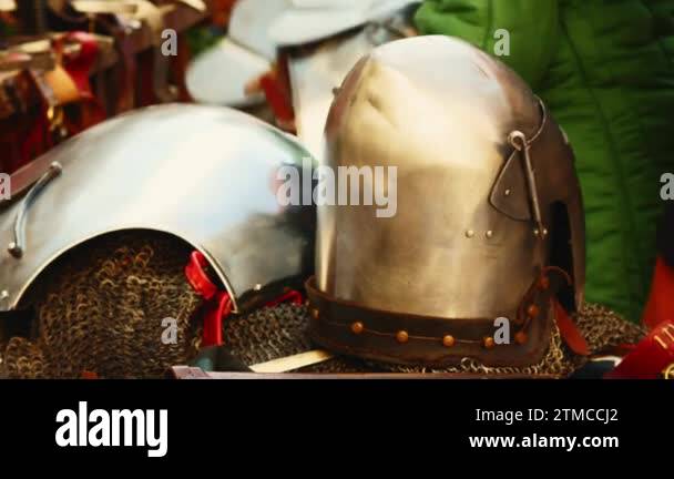 medieval reenactment - men in European medieval dress arrange a rack of ...