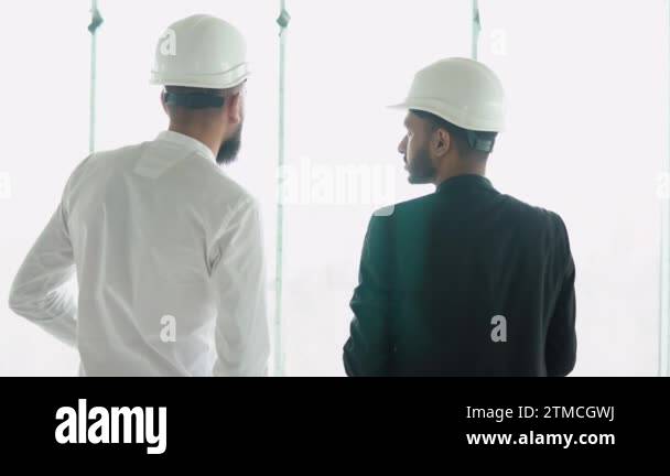 Indian and arabian architects builders meeting at construction site ...