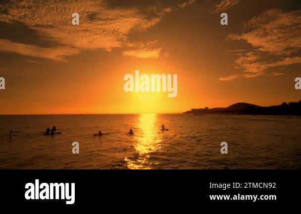 Surfers rides big wave against backdrop beautiful sunset on the sea ...