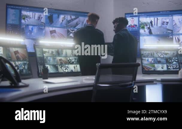 Multi ethnic employees talk and control CCTV cameras with AI face ...