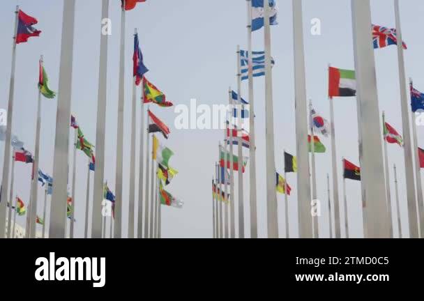 bottom view footage of flags of world waving on blue sky background ...