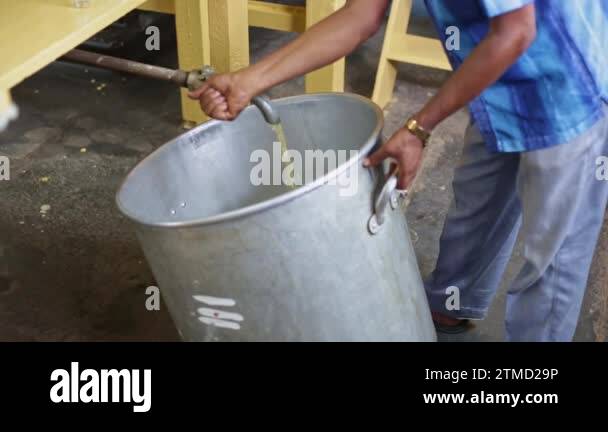 Steel container being filled with an extracted or purified liquid soap ...