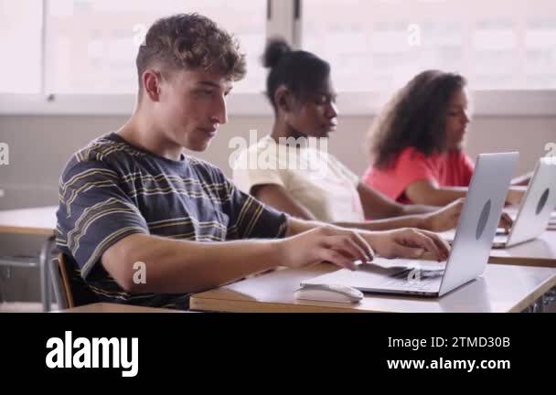 Multi-ethnic group of three young high school students study together ...