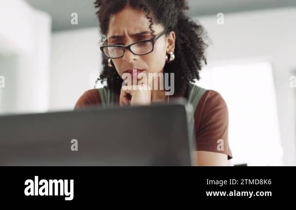 Laptop, stress and doubt with a business woman in her office, reading an email while feeling ...