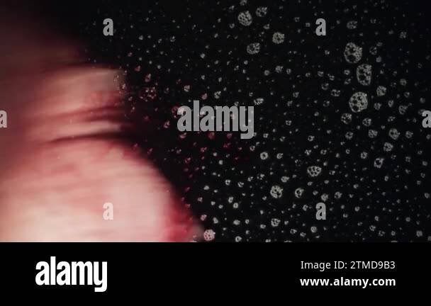 Bloody hand wiping a window glass with bloody rag deep dark background ...