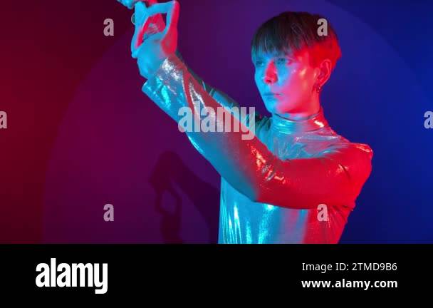 Concentrated young adult woman making viewfinder hand gesture in ...