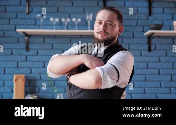Behind the bar counter, a charming and charismatic bartender with a big ...