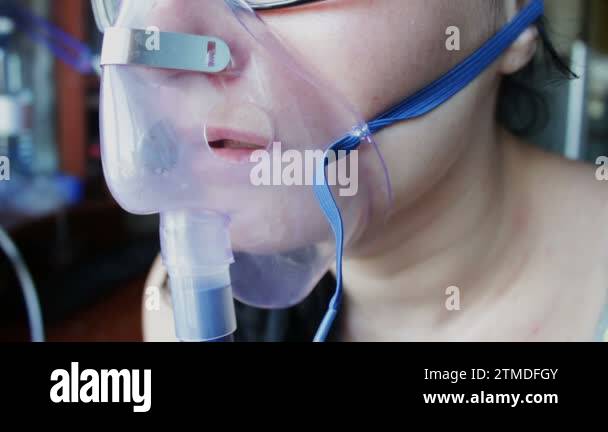 Girl is Breathing a Steam Through an Inhaler patiently Stock Video ...