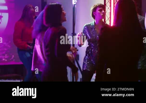 Crowd of people dancing in the club with electronic music, feeling ...