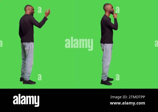 Confident man doing silence mute sign and calling over someone to join ...