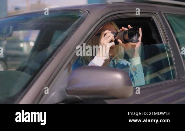 Paparazzi woman or girl sits in her car and takes pictures of famous ...