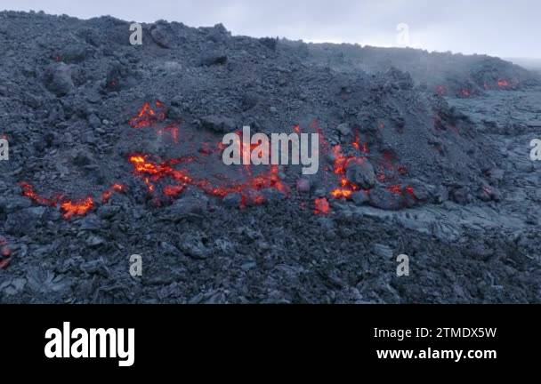 Natural aerial shot on drone of red hot lava flowing and freezing with ...