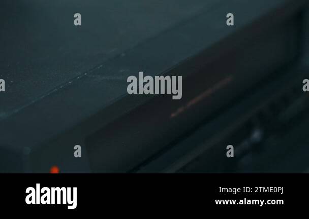 Eject VHS tape cassette from VCR player. Male hand pushes a button and ...