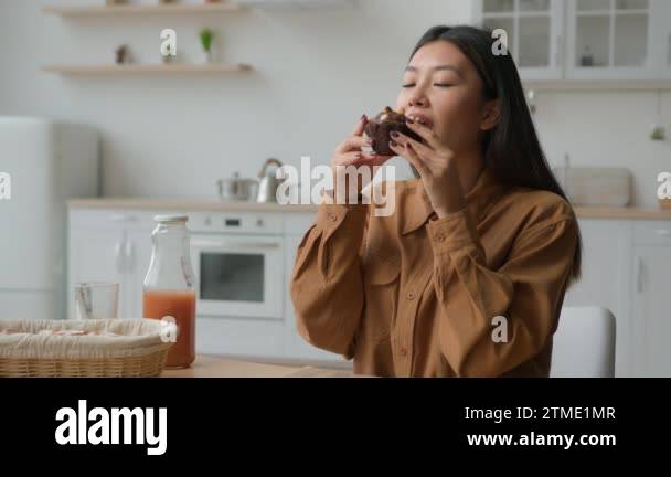Moving camera shot Asian korean chinese hungry woman girl in kitchen ...