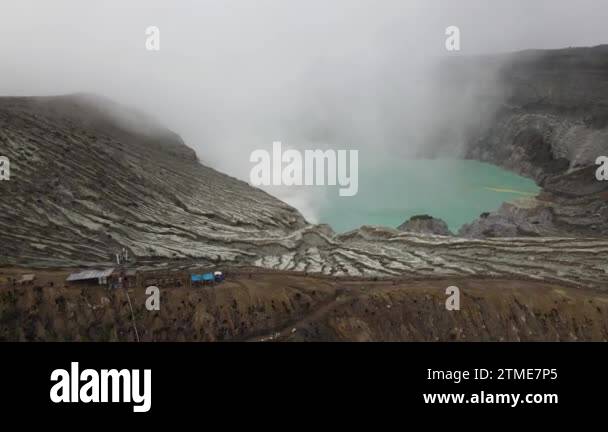 Dramatic aerial view of a crater acid lake Kawah Ijen where sulfur is ...