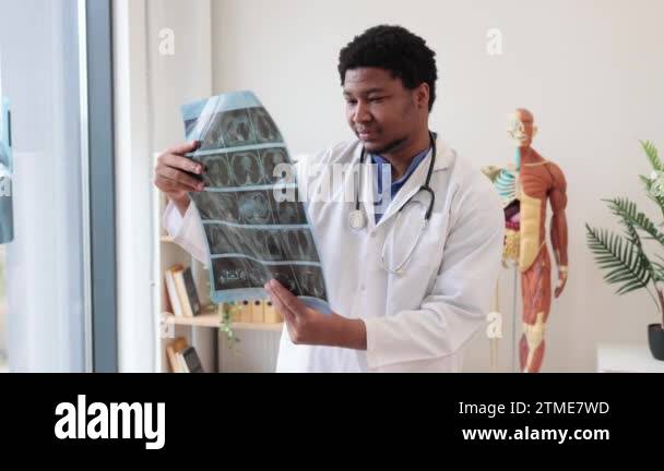 Confident african american man in doctors coat with stethoscope holding ...