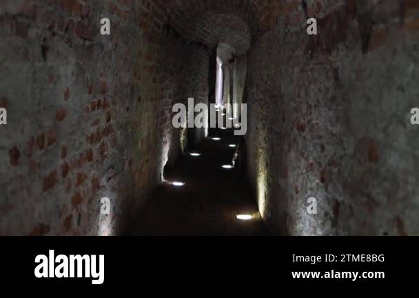 Stone dark corridor of ancient catacombs. Tomb inside old castle ...