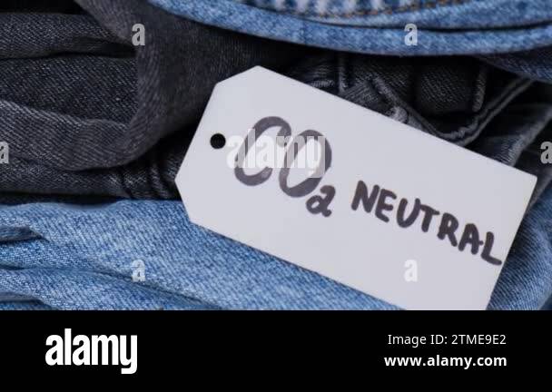 CO2 neutral emission text note on stack of jeans. Ecology nature ...
