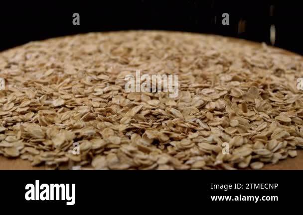 Dry Oat Flakes Falling in Pile Raw Oatmeal on Black Rotating Background ...