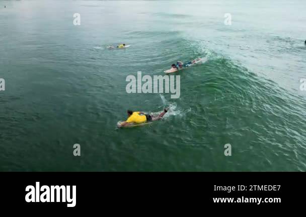 Surfers rides big wave in Vietnam. Sportsmans, happy people, happy with ...
