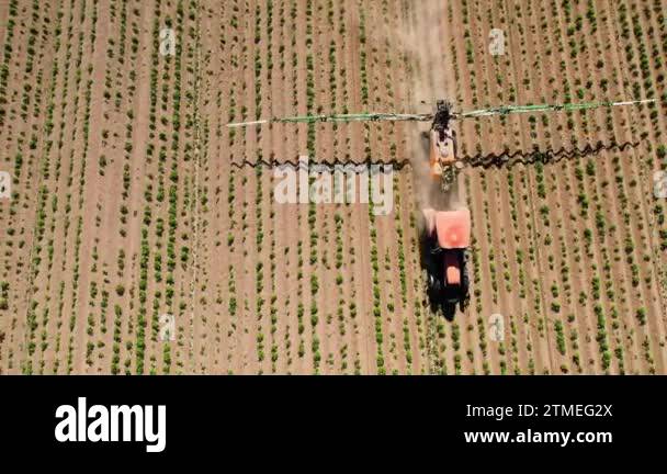 Tractor with pesticide fungicide insecticide sprayer on farm land, top ...