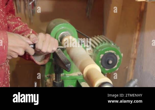 Foot operated spring pole wood lathe.Man operating a foot operated ...