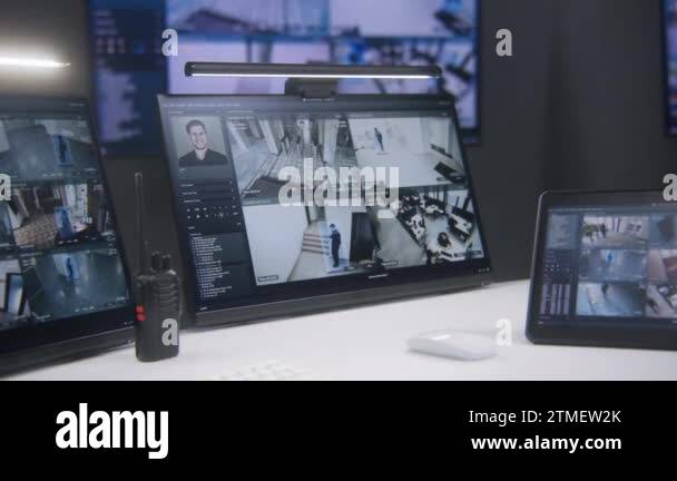 Computer monitors and tablet showing video footage of surveillance CCTV ...