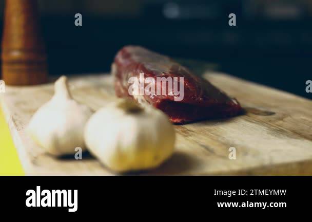 Chef cleans raw meat and cuts off connective tissue and surface ...